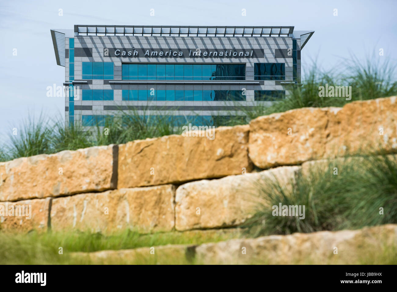 A logo sign outside of the headquarters of Cash America International ...