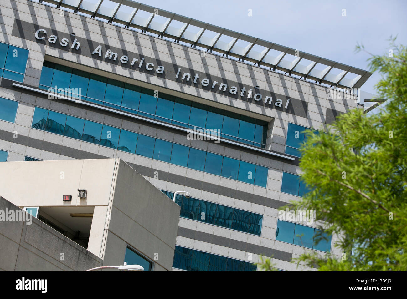 A logo sign outside of the headquarters of Cash America International ...