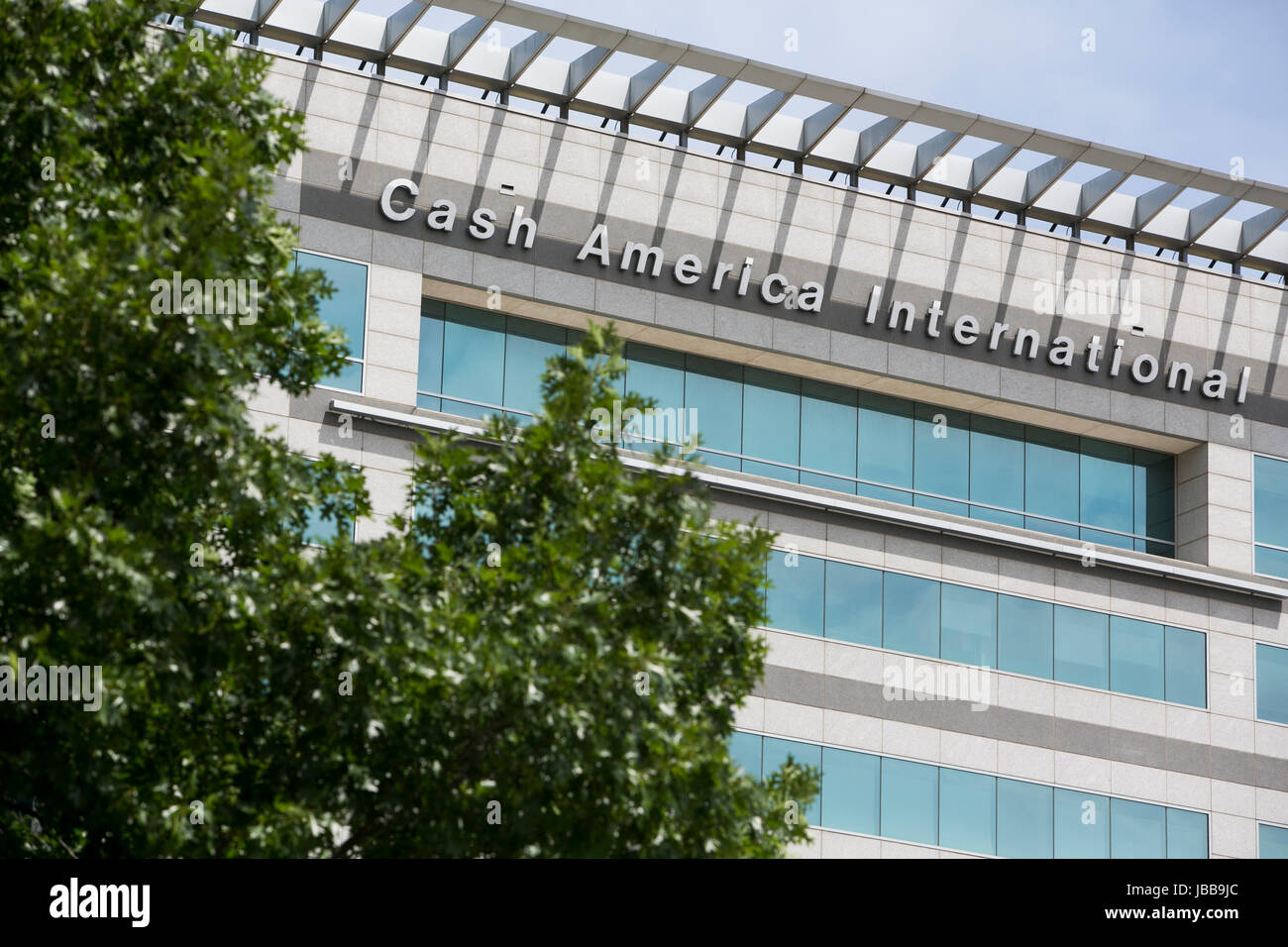 A logo sign outside of the headquarters of Cash America International ...