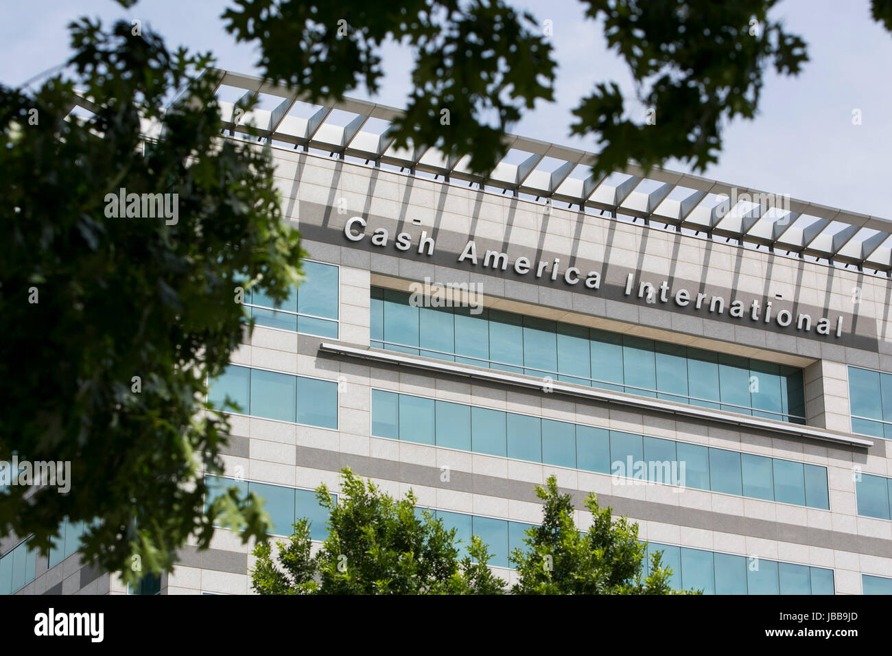 A logo sign outside of the headquarters of Cash America International ...