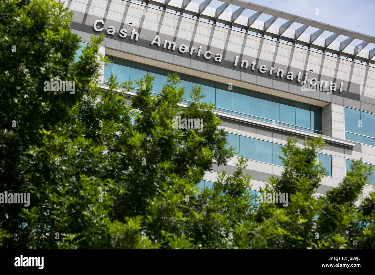 A logo sign outside of the headquarters of Cash America International ...