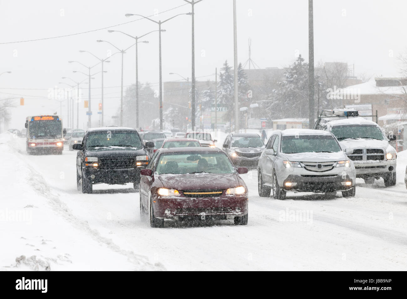 Cars driving on slippery road during heavy snowfall in Toronto Stock ...