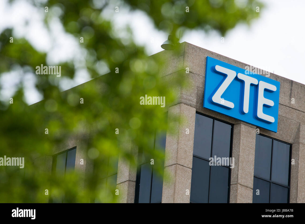 A logo sign outside of a facility occupied by the ZTE Corporation in ...