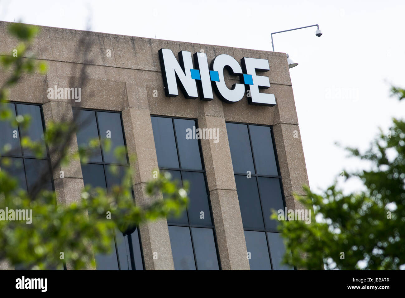 A logo sign outside of a facility occupied by Nice Systems in ...