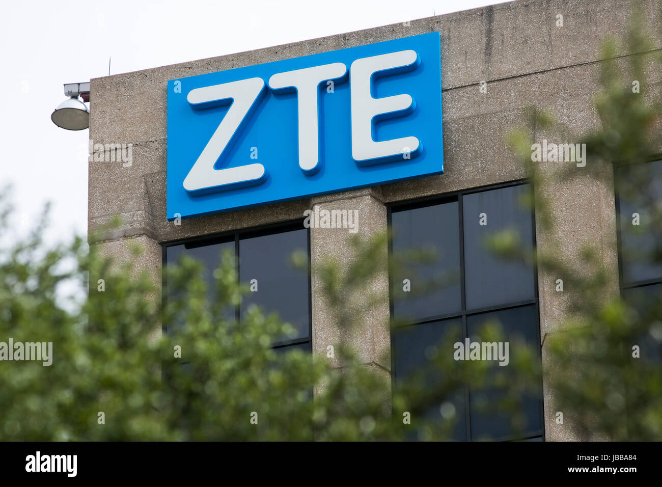 A logo sign outside of a facility occupied by the ZTE Corporation in ...