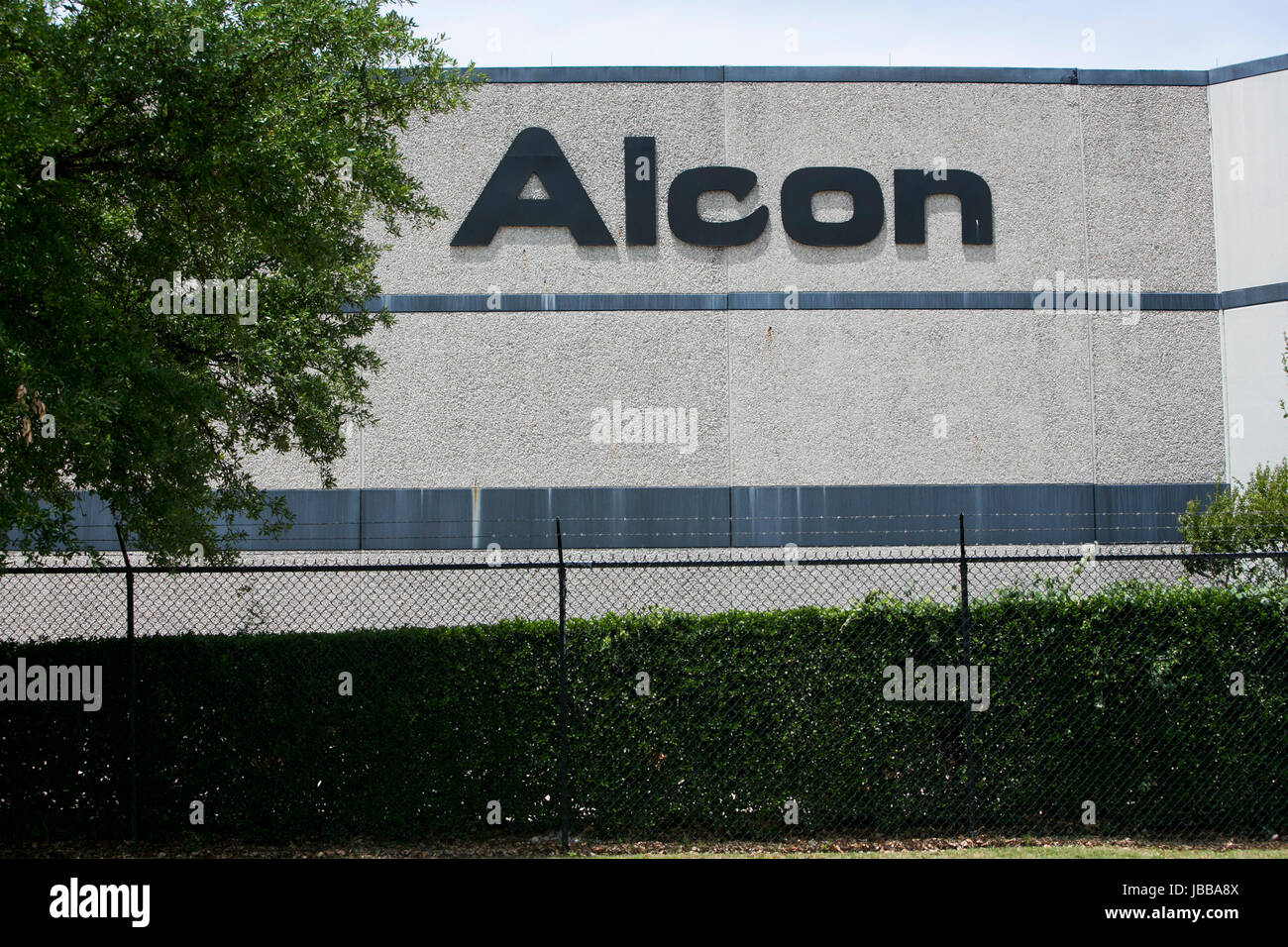 A logo sign outside of a facility occupied by Alcon in Fort Worth ...