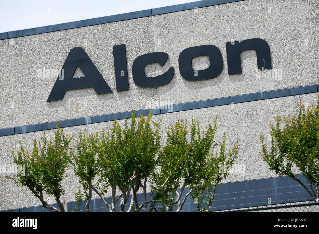 A logo sign outside of a facility occupied by Alcon in Fort Worth ...