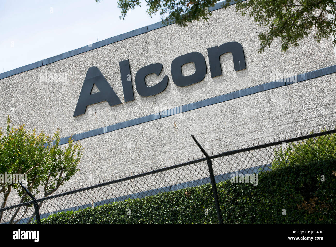 A logo sign outside of a facility occupied by Alcon in Fort Worth ...