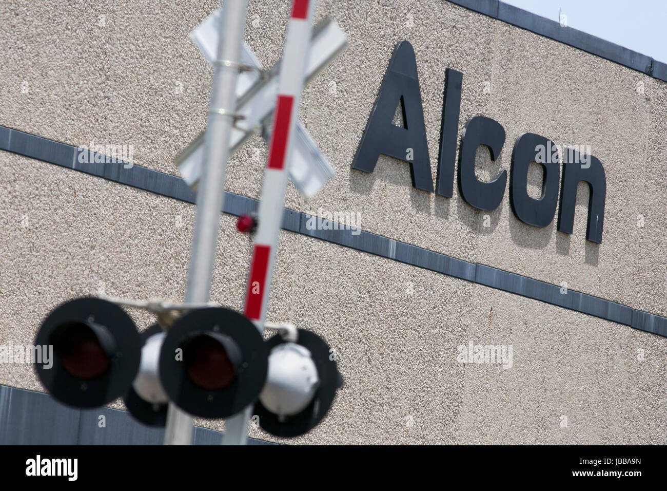 A logo sign outside of a facility occupied by Alcon in Fort Worth ...