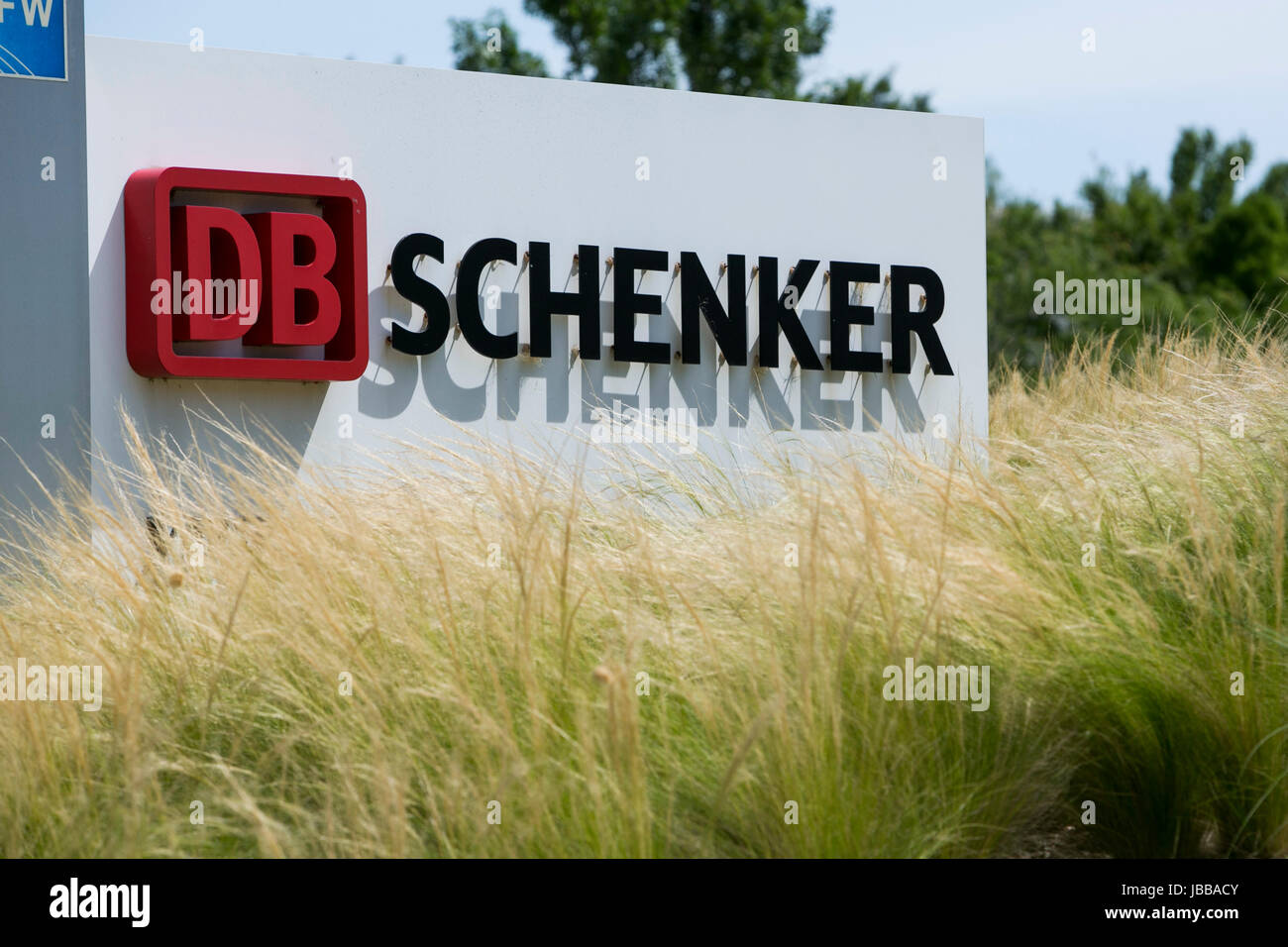 A logo sign outside of a facility occupied by DB Schenker in Dallas ...