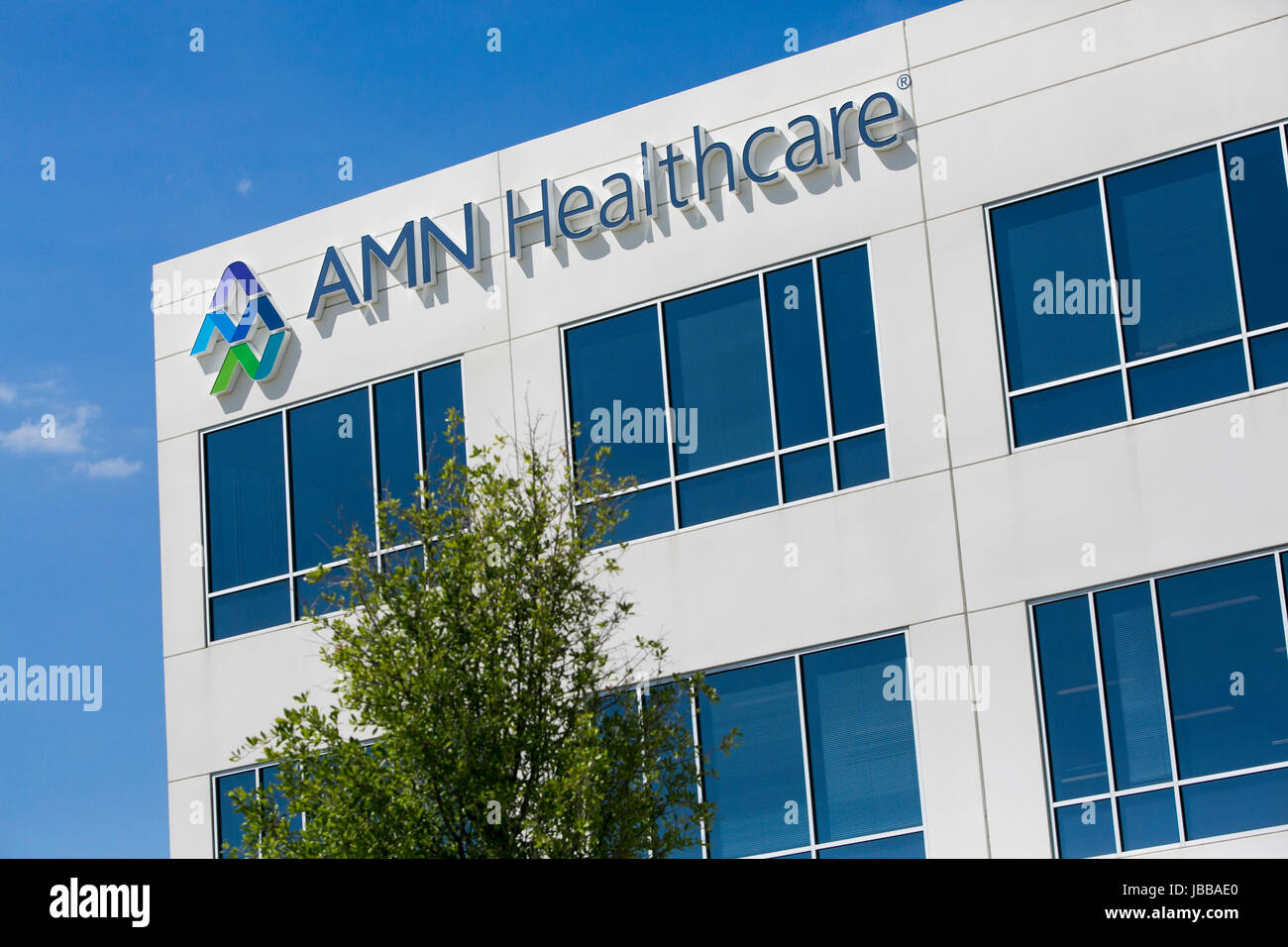 A logo sign outside of a facility occupied by AMN Healthcare in Coppell ...