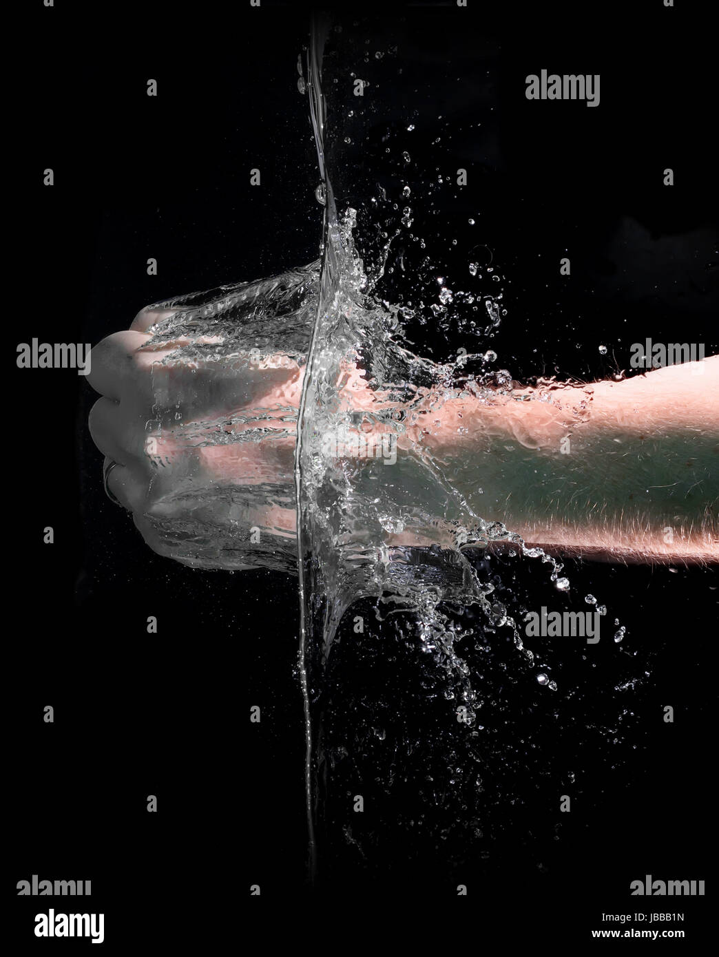 Fist punch into water with big splashes, on a black background Stock ...