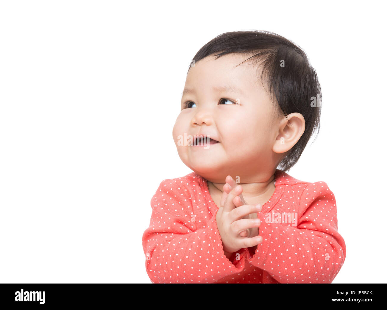 Asia baby girl clapping hand and looking at aside Stock Photo - Alamy