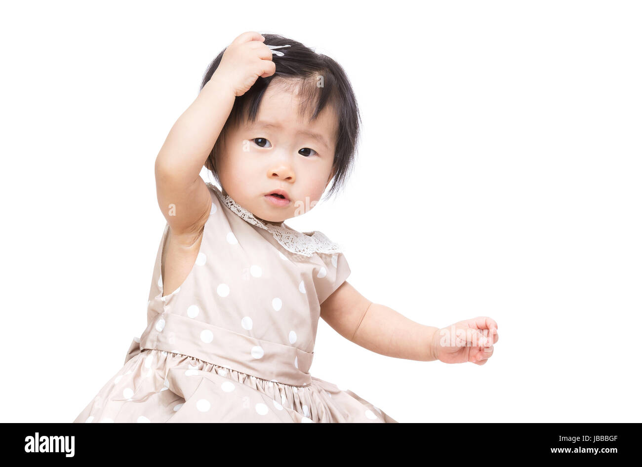 Asia baby girl scratch her hair Stock Photo - Alamy