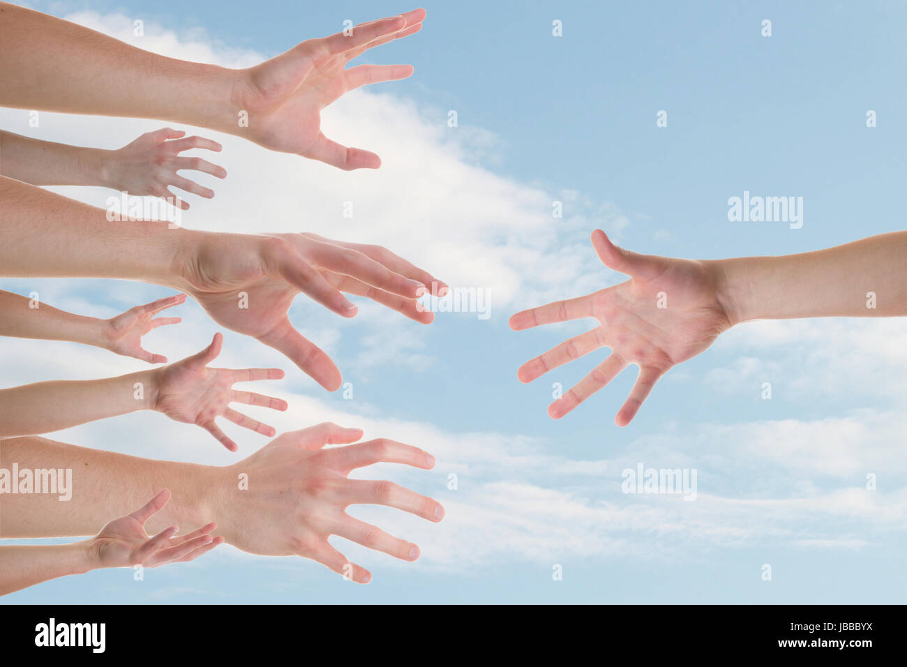 Several caucasian hands reaching for the helping hand Stock Photo - Alamy