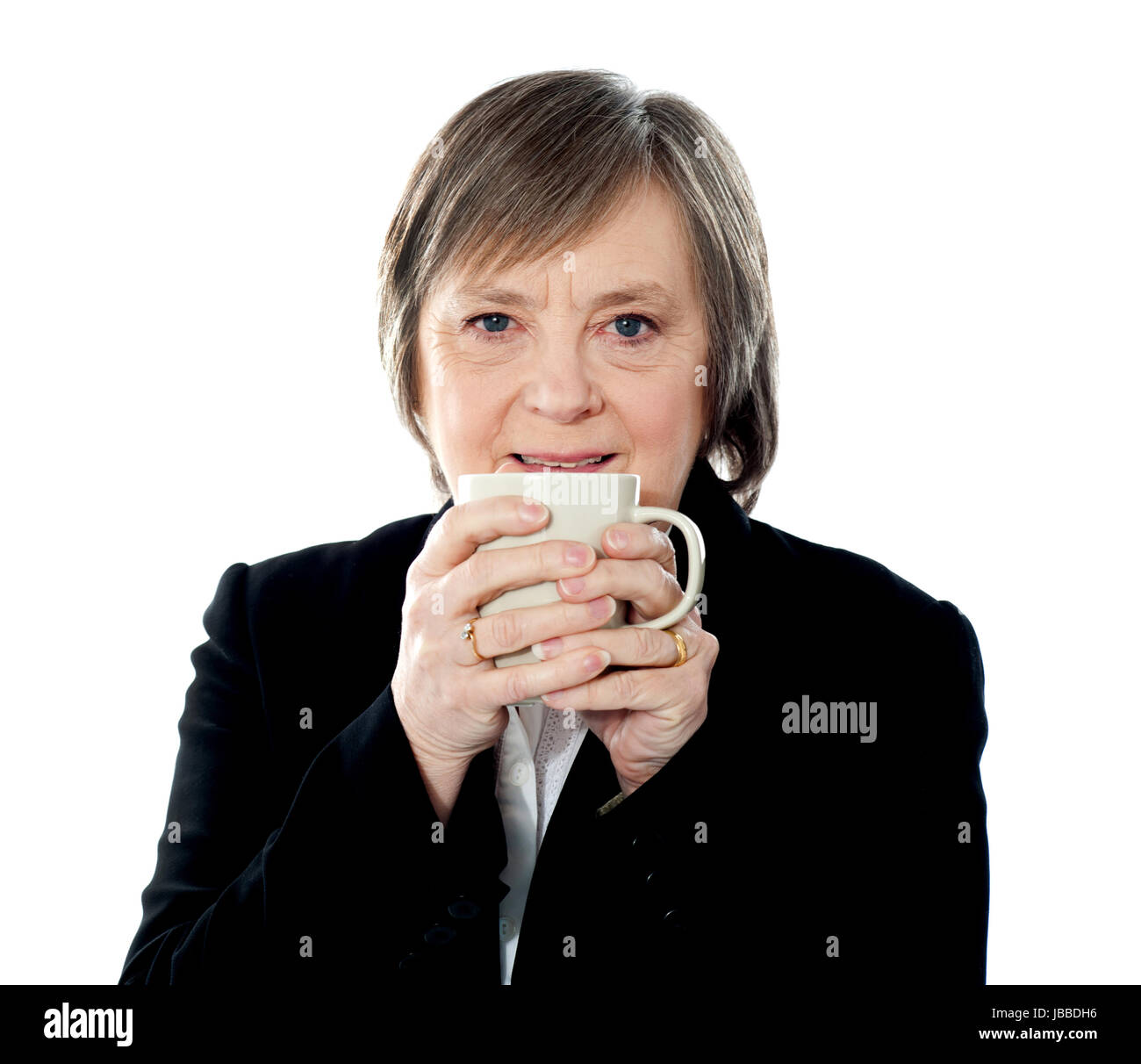 Old woman holding coffee mug, sipping hot coffee Stock Photo - Alamy