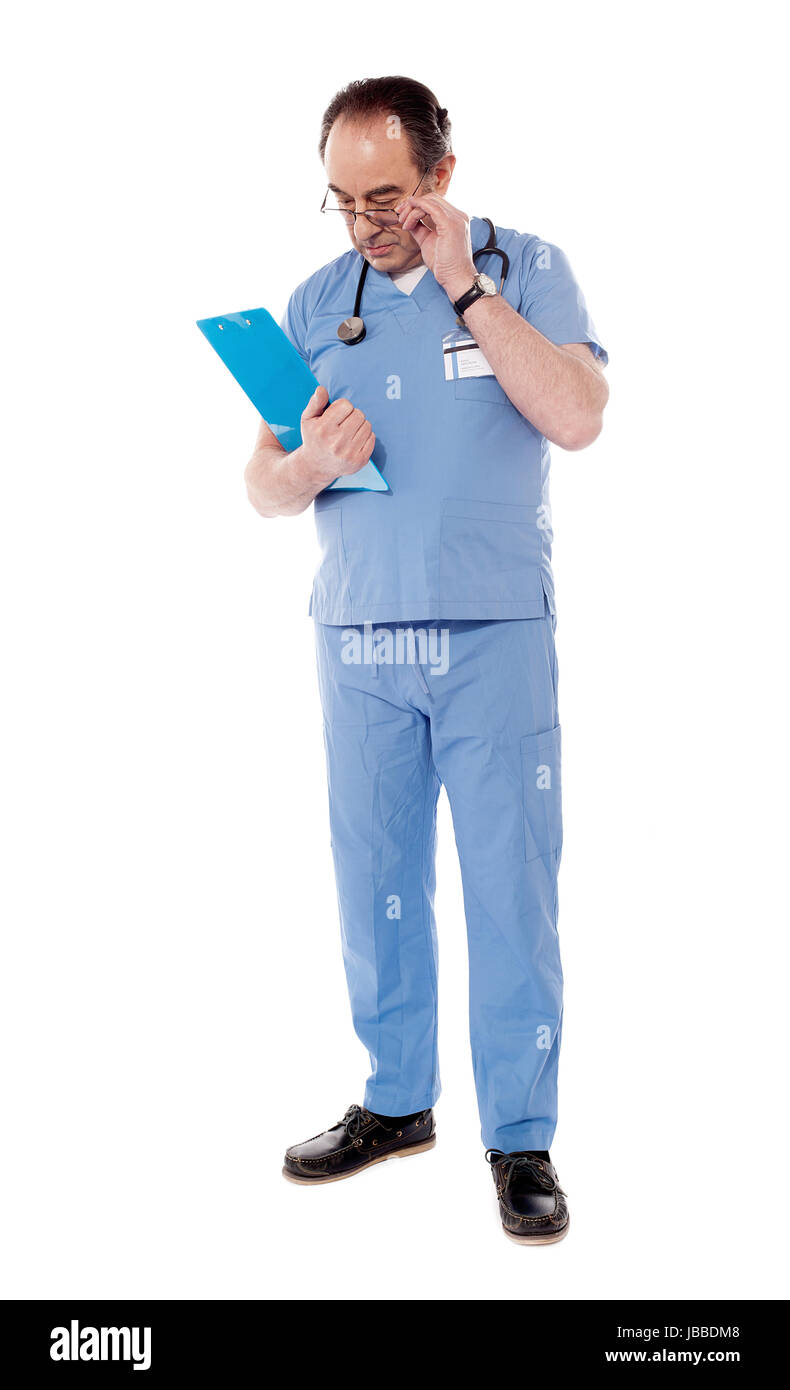 Experienced doctor looking at reports isolated on white background ...