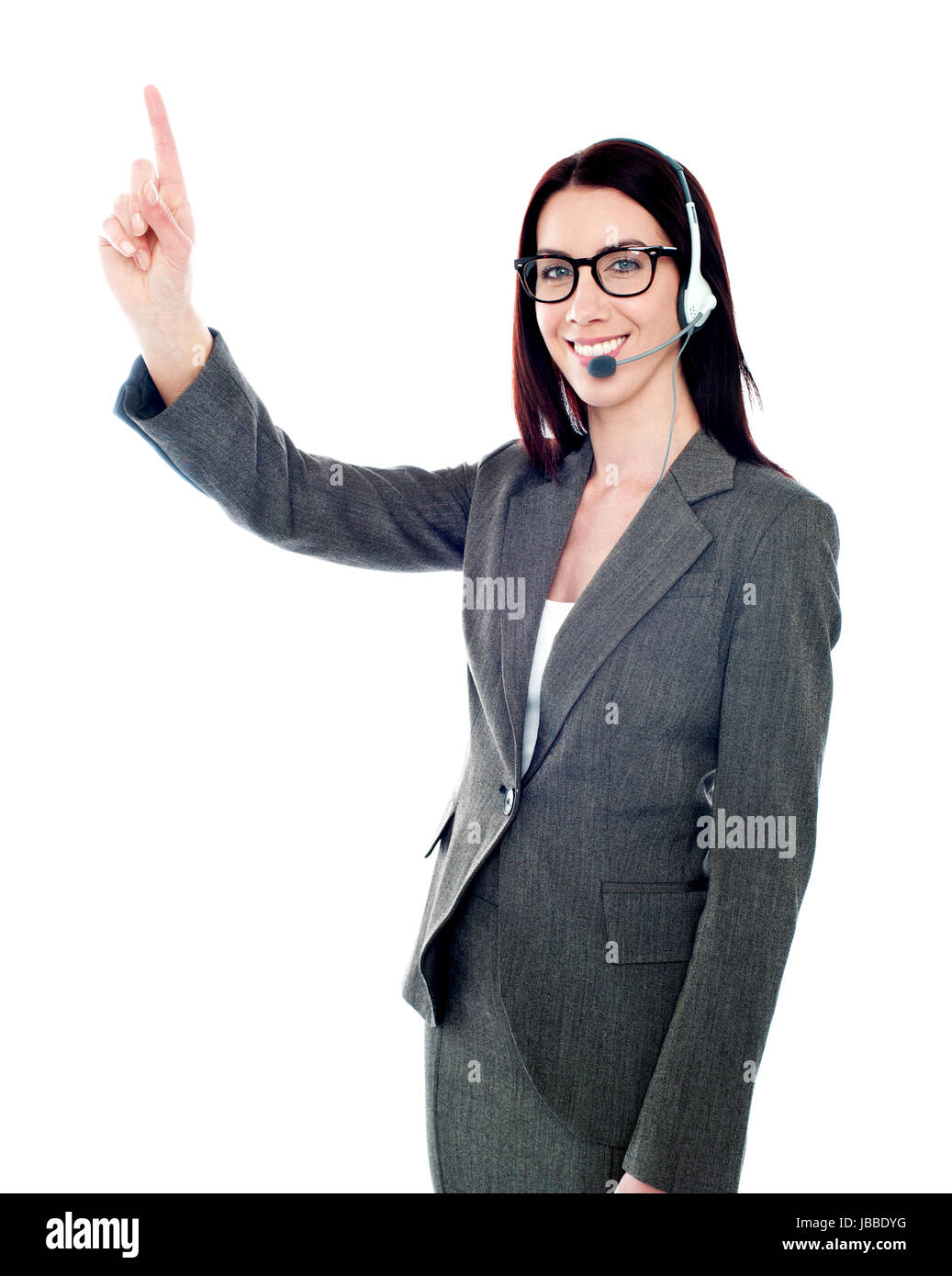 Beautiful customer care executive pointing up at copyspace over white ...