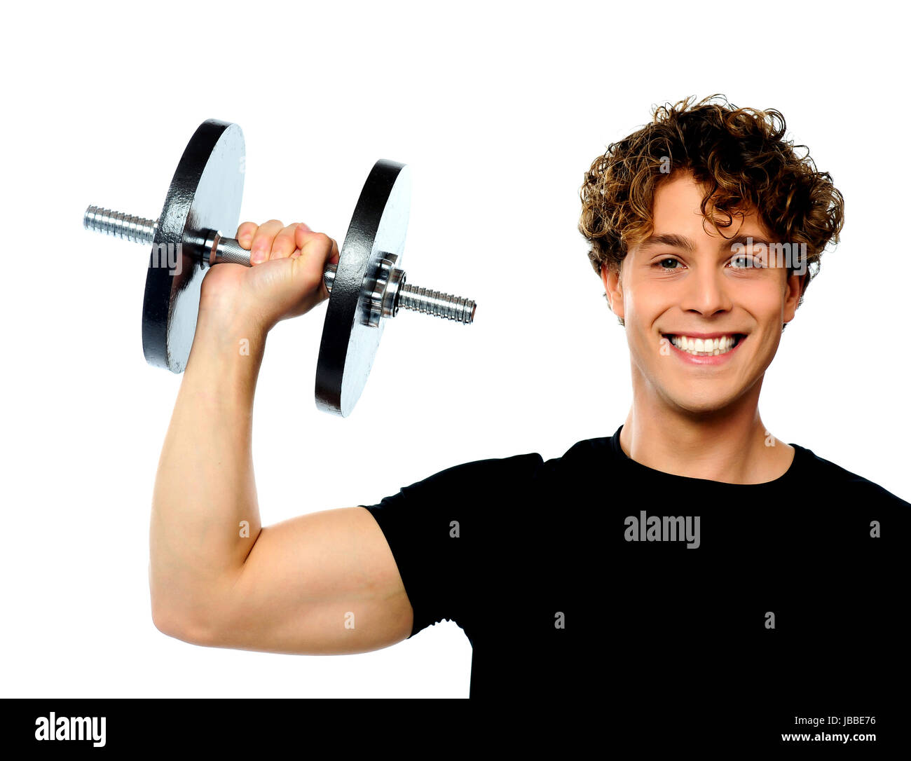 Powerful muscular young man lifting weight, smiling pose Stock Photo ...