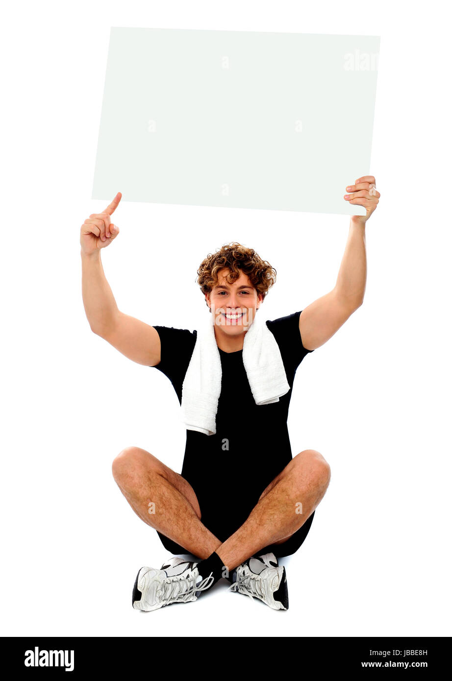 Athlete pointing towards blank banner ad over his head Stock Photo - Alamy