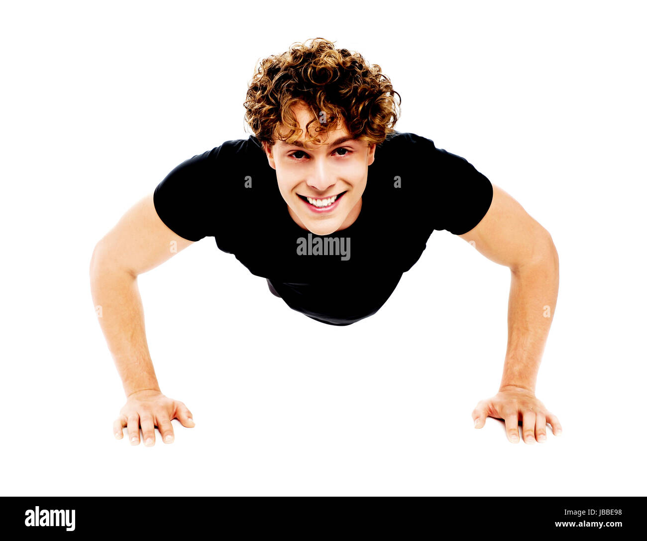 Healthy young guy doing push-ups exercise against white background ...