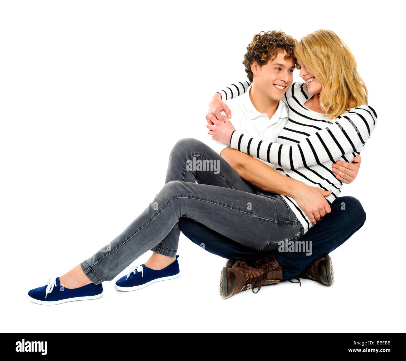 Couple Looking At Each Other Girl Sitting On Lap Of Her Partner