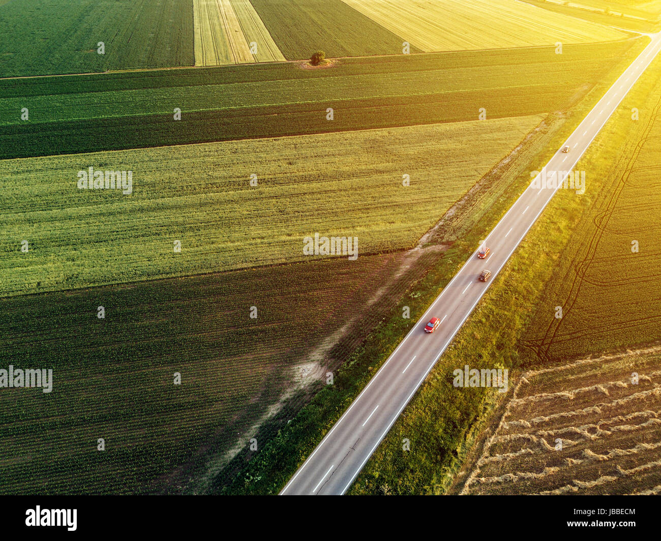 Aerial view of traffic on two lane road through countryside and ...