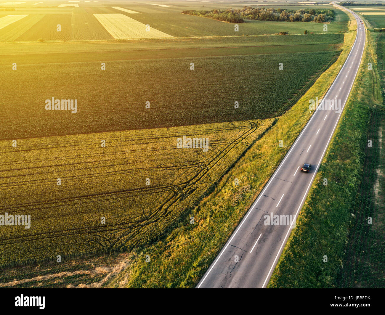 Aerial view of traffic on two lane road through countryside and ...