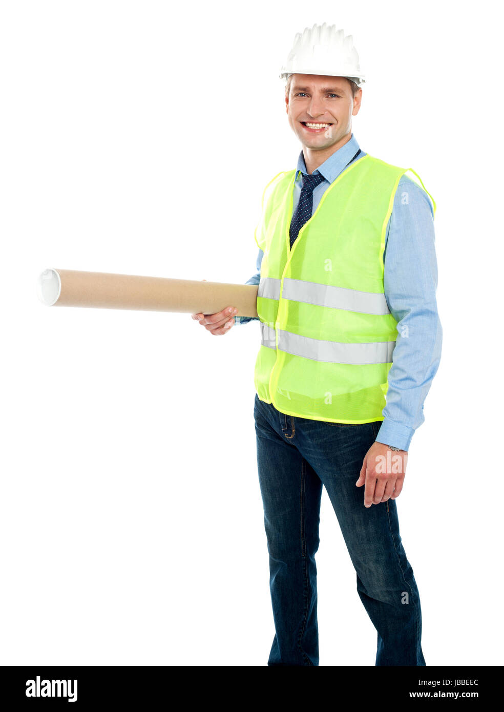 Smiling young architect holding blueprint. Wearing helmet and safety ...