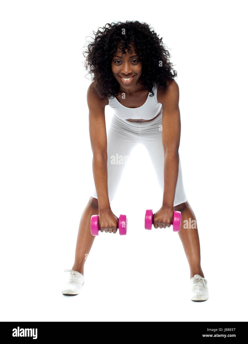 Fit woman exercising. Bending down holding dumbbells Stock Photo - Alamy