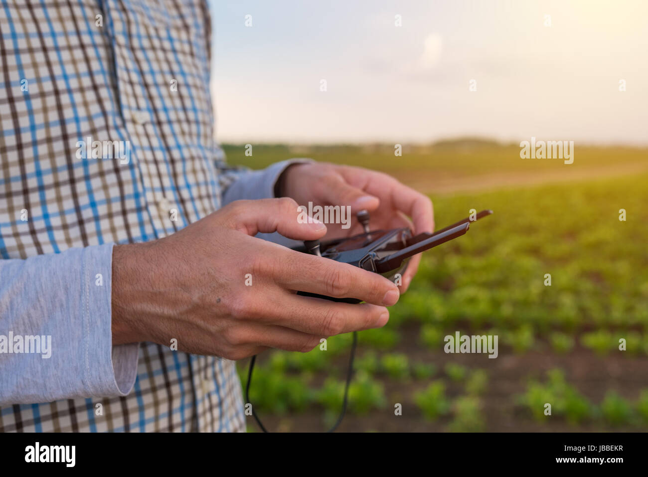 Hands of farmer using drone remote control, smart farming agricultural ...
