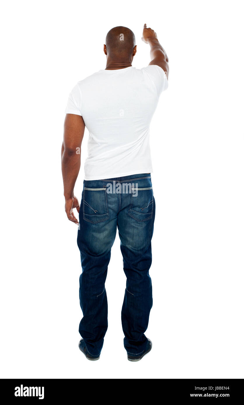 Rear view of strong young man pointing at copyspace isolated against ...