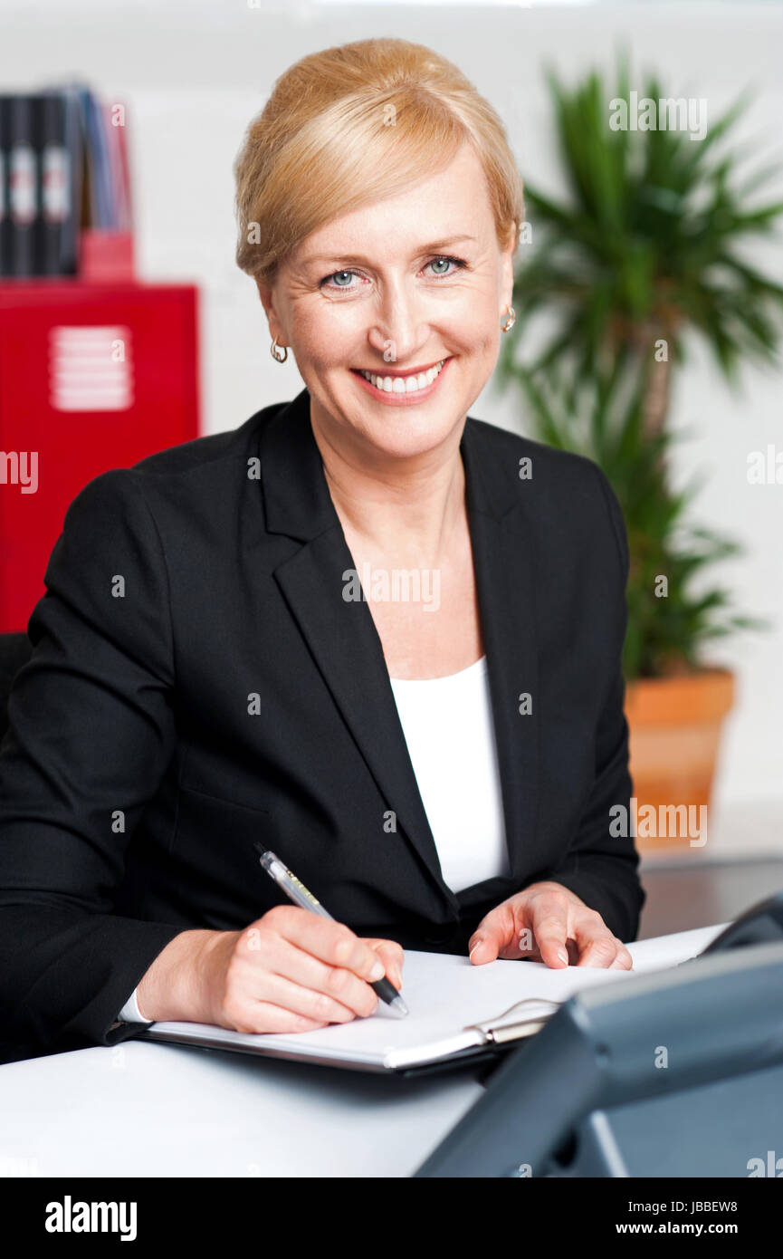Seated female secretary writing hi-res stock photography and images - Alamy