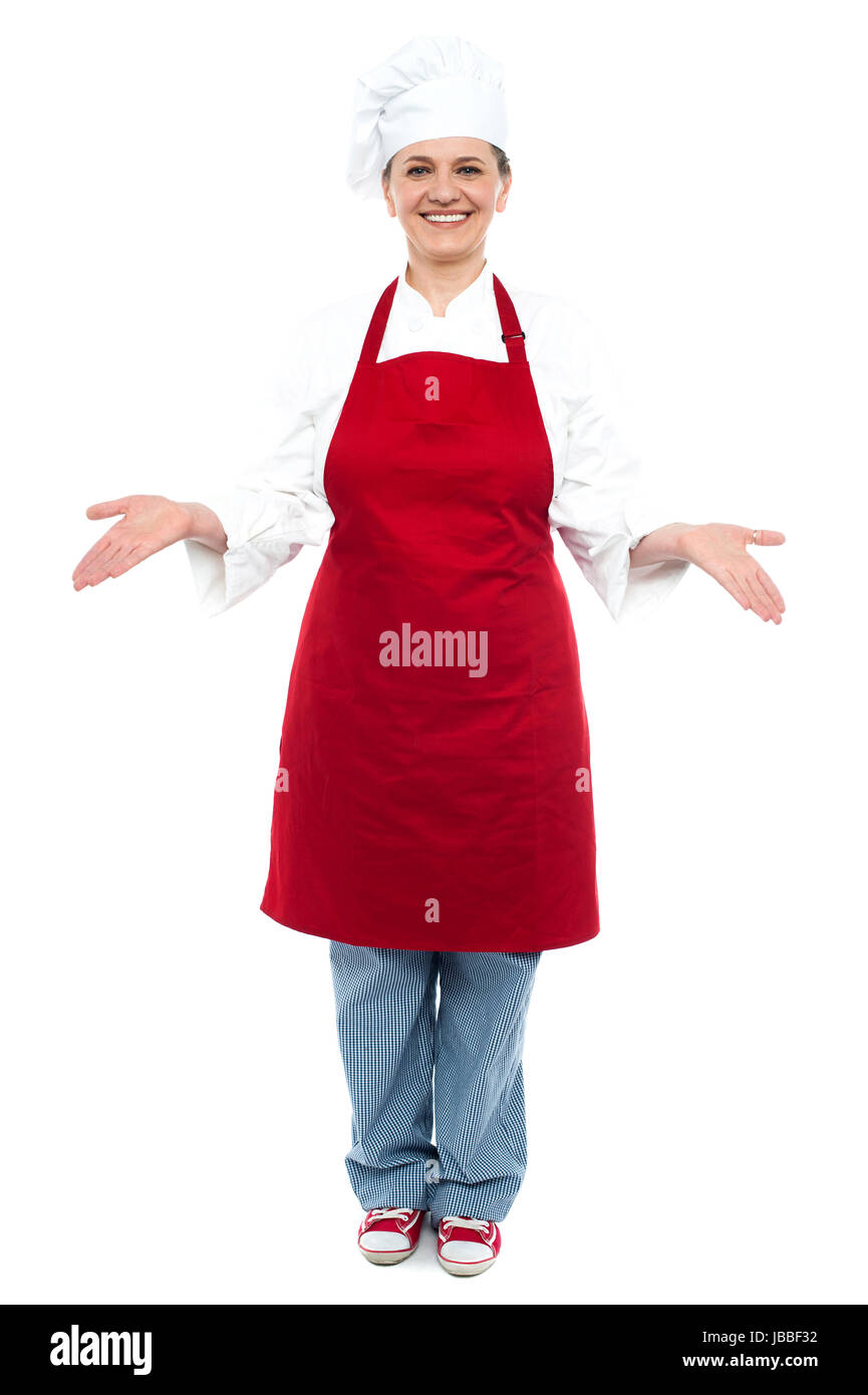 Female chef welcoming you with a smile, full length shot Stock Photo ...