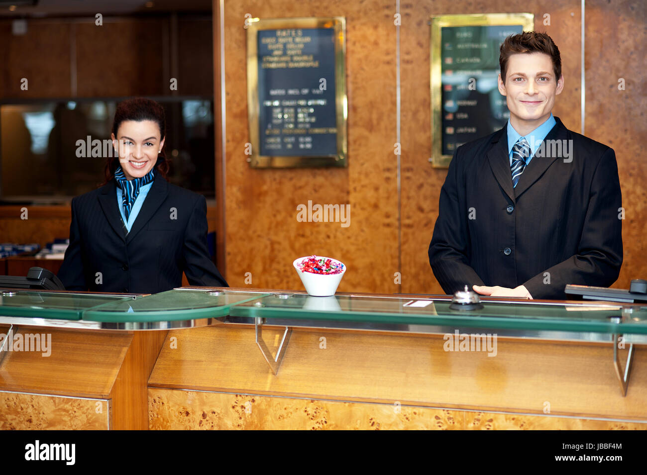 Front desk colleagues posing for a picture. Smiling cheerfully while ...