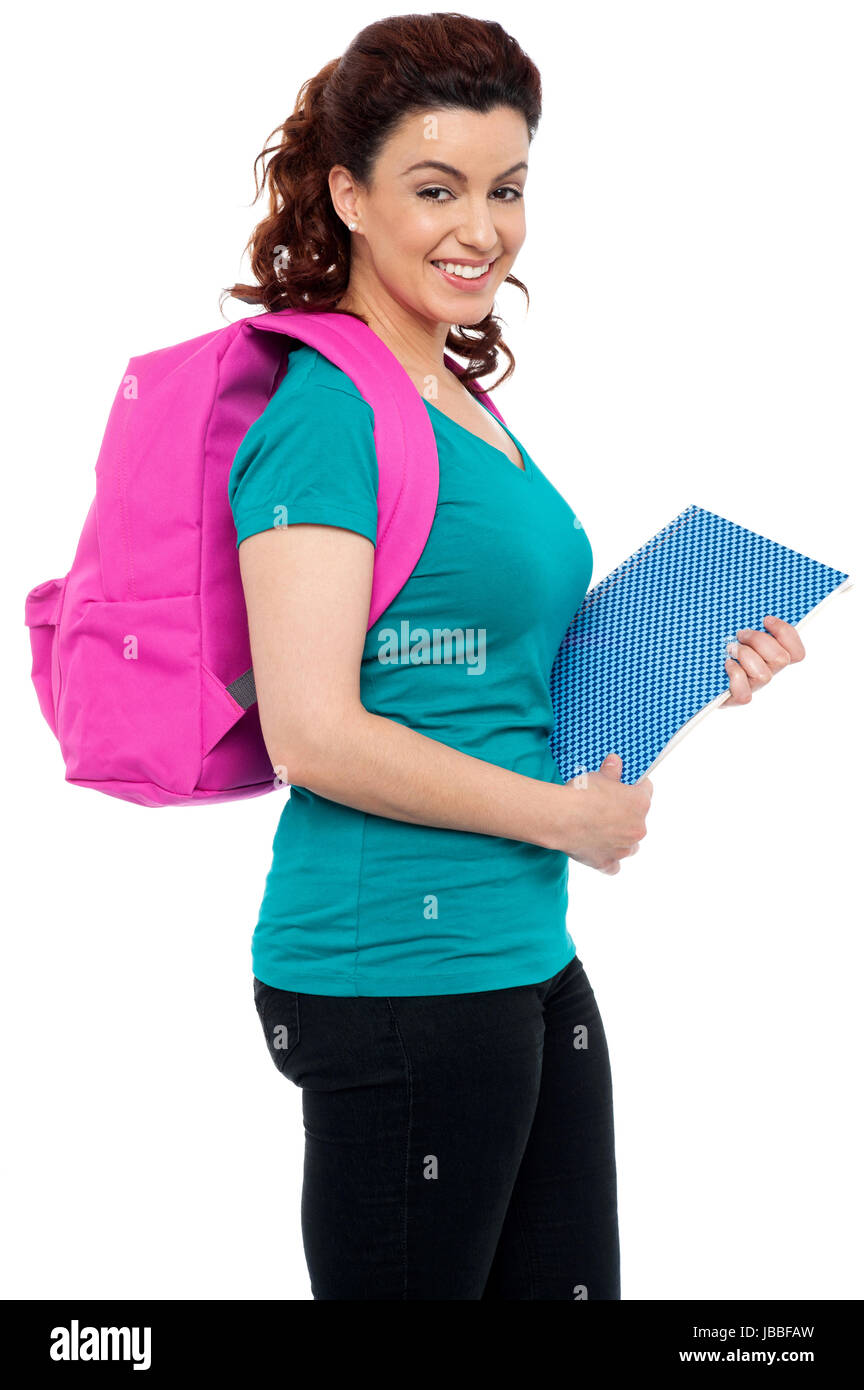Side view of attractive smiling college girl carrying backpack and ...