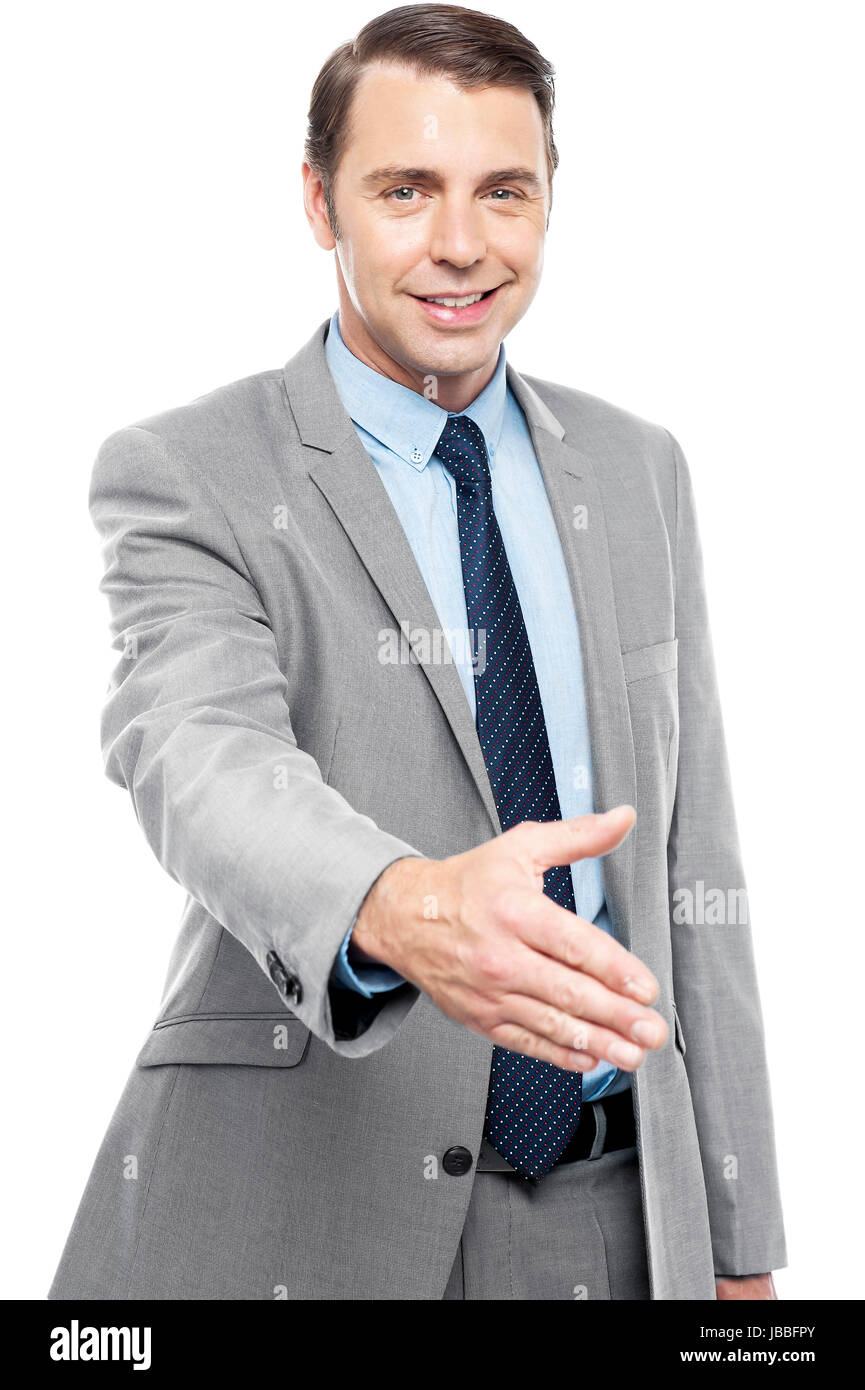 Young smiling male executive welcoming you with a handshake isolated ...