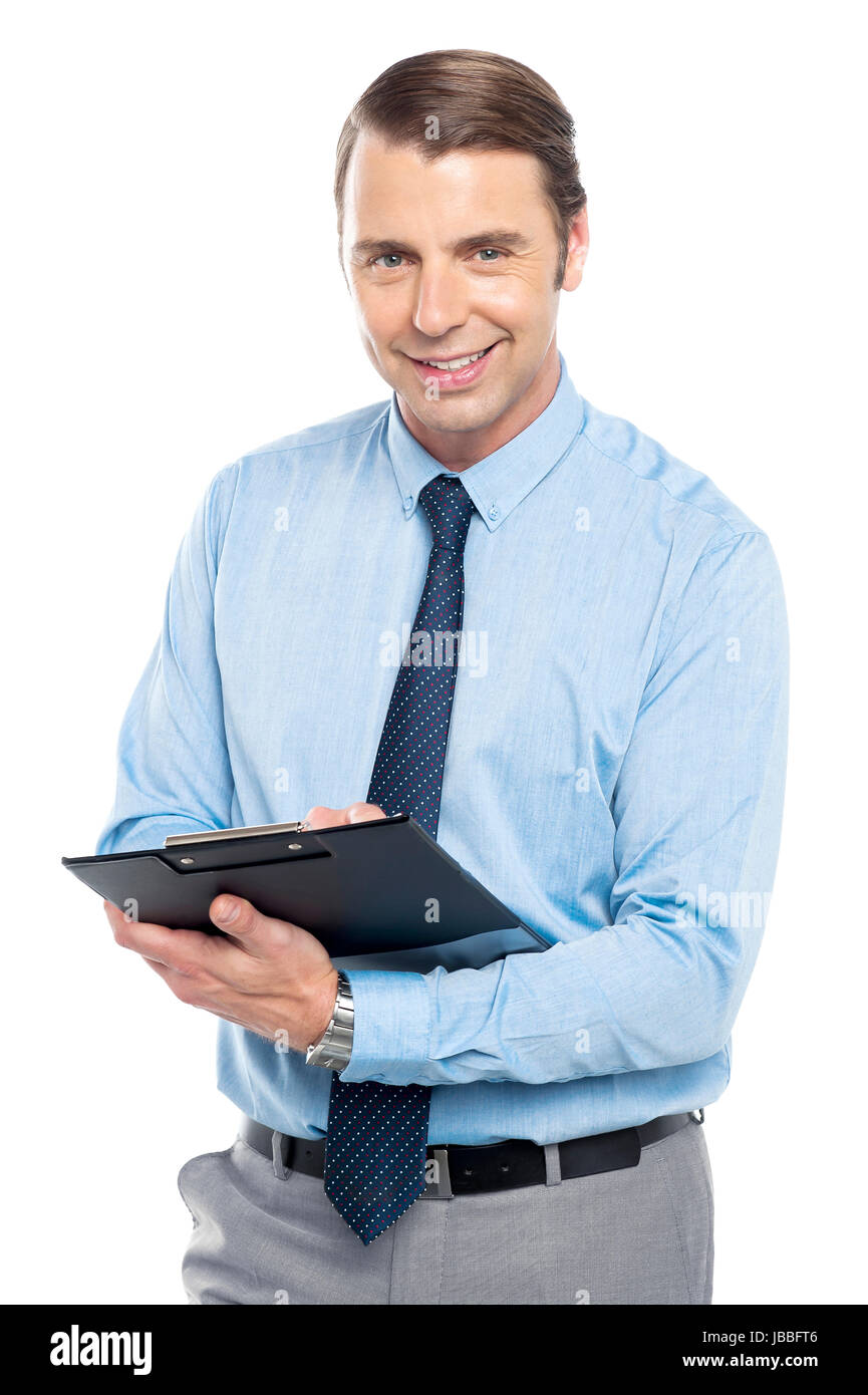 Smiling male secretary holding a clipboard ready to take down notes ...
