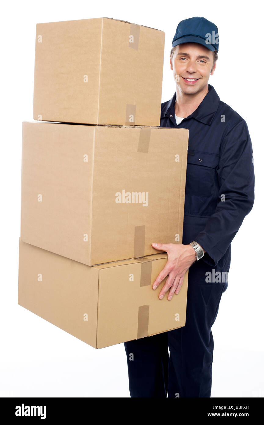 Working man delivering stack of cardboard boxes. Courier delivery Stock ...