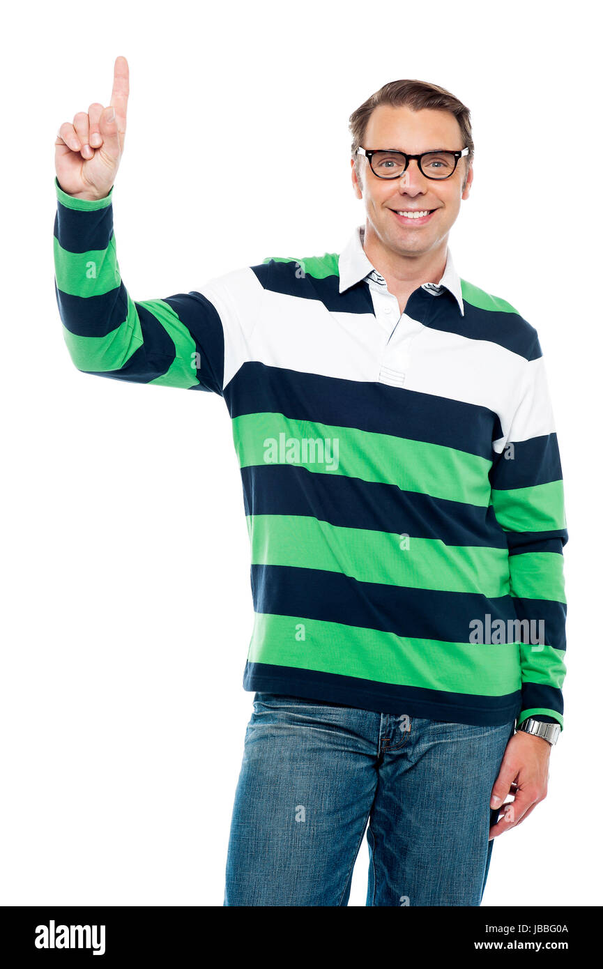 Smiling young man with raised finger. Excuse me, may I Stock Photo - Alamy