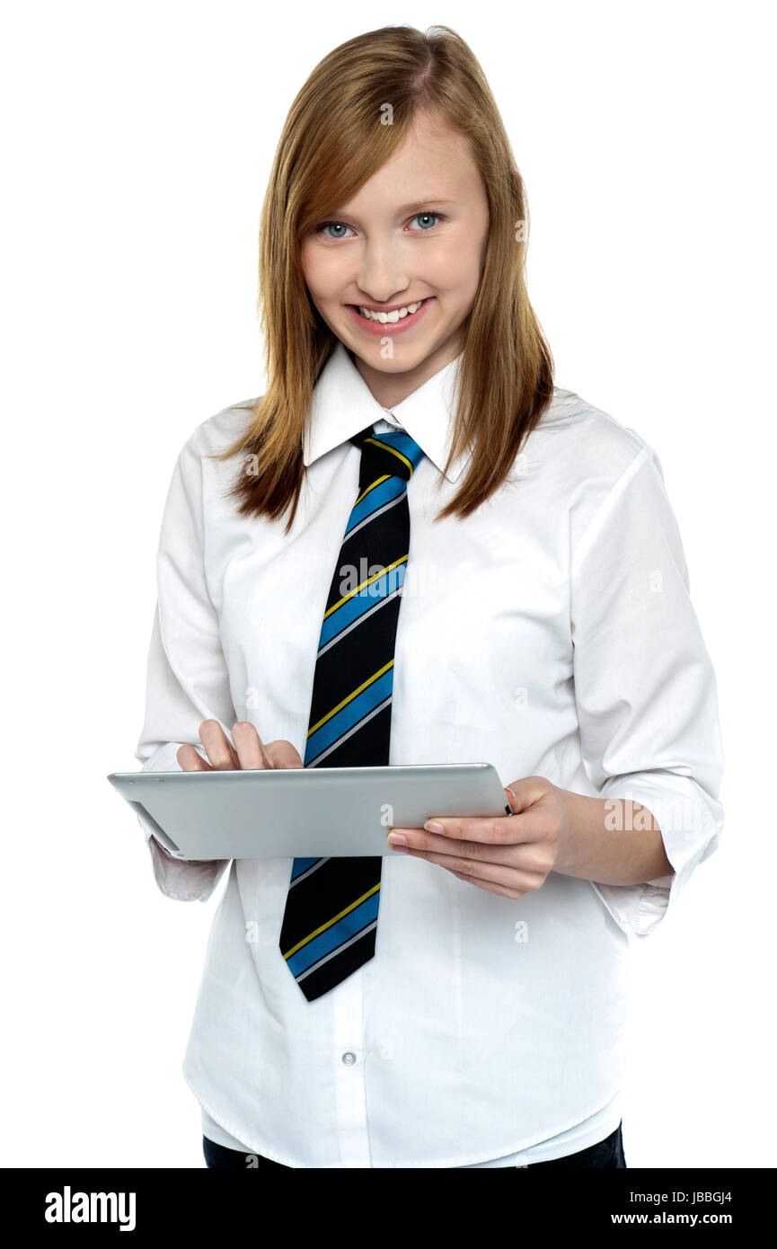 Cheerful student in school attire using tablet pc. Half length portrait ...