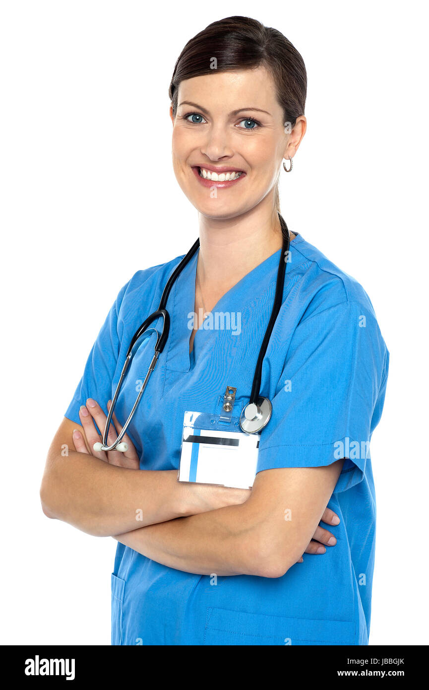 Profile shot of a cheerful doctor standing with her hands crossed on ...