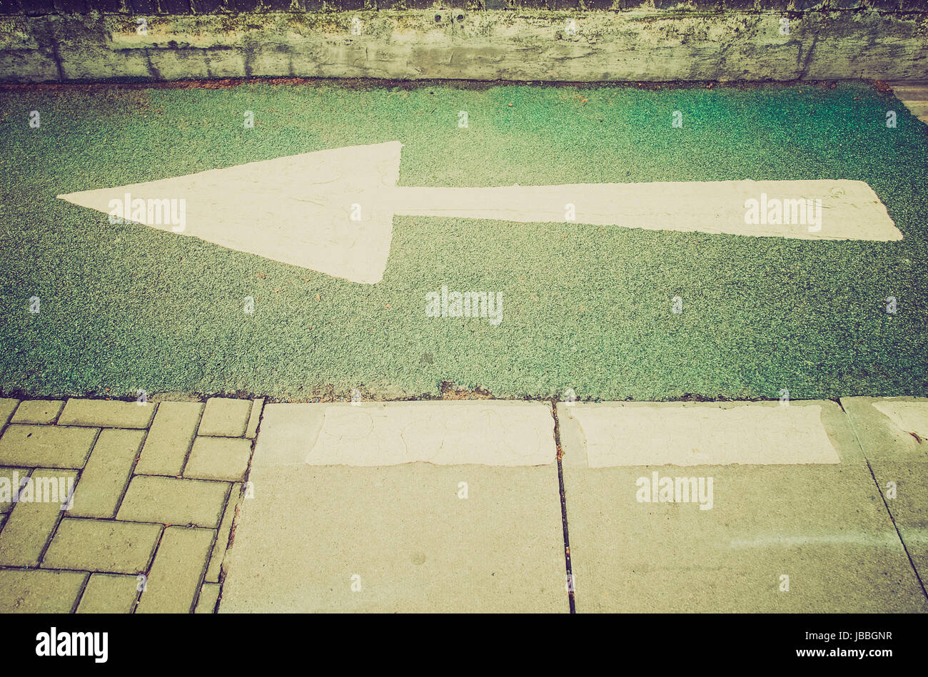 Vintage retro looking Arrow sign showing street road driving direction ...