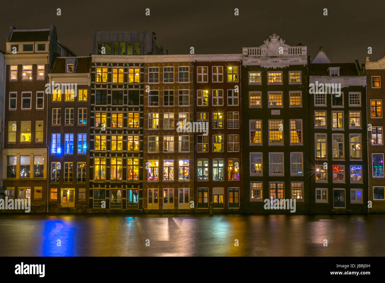 Amsterdam buildings at night with colorful windows Stock Photo - Alamy