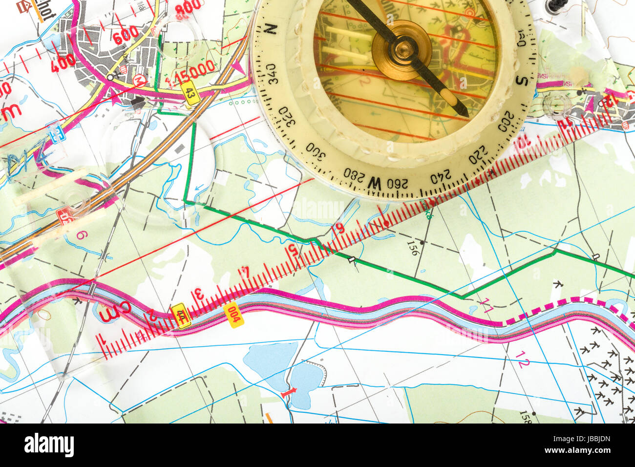 old touristic handheld compass on detailed territory map Stock Photo ...