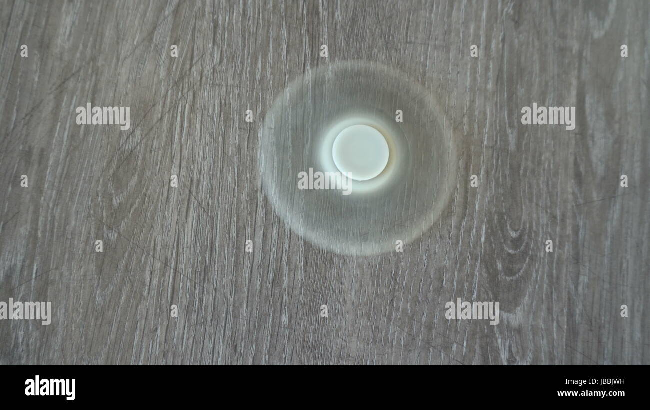 white hand spinner, or fidgeting spinner, rotating on the floor Stock ...