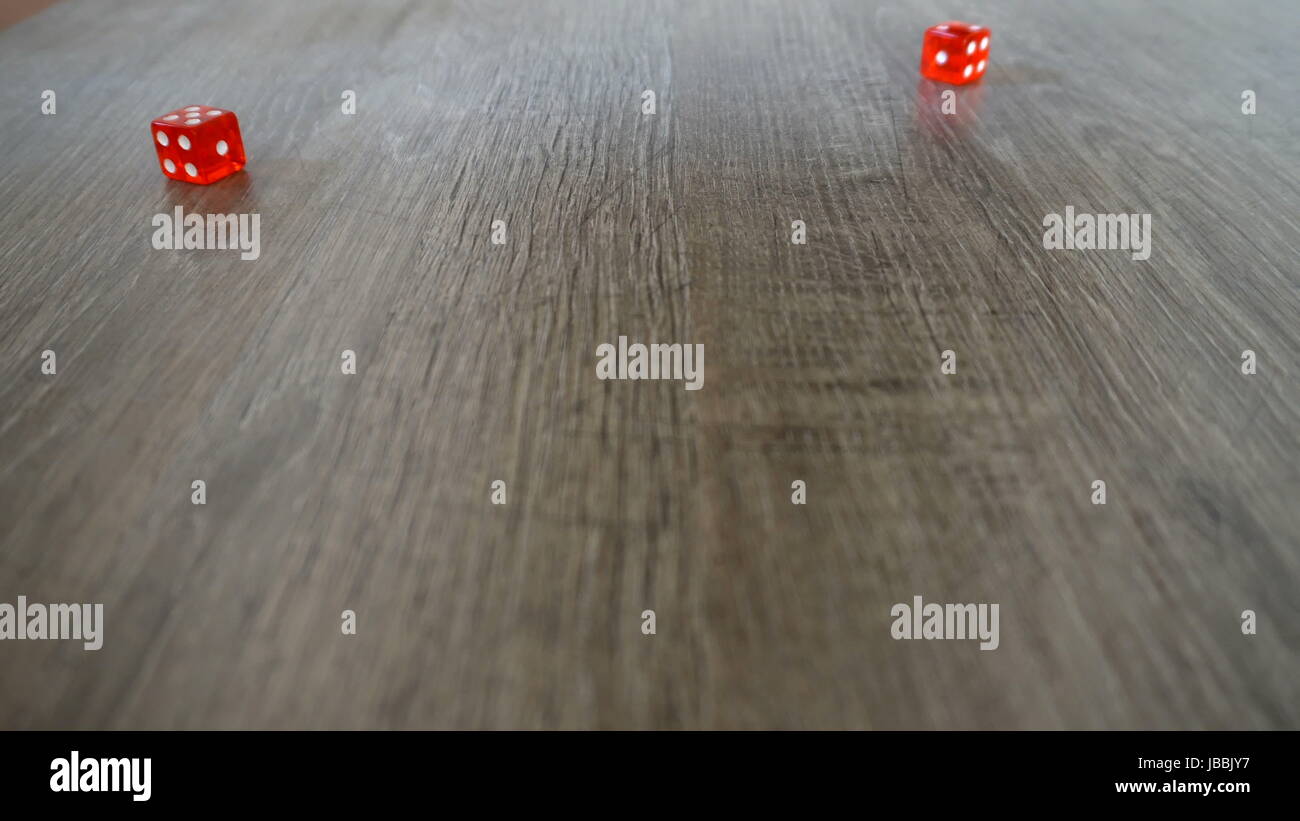 Throwing red dice on a grey background in the casino Stock Photo - Alamy