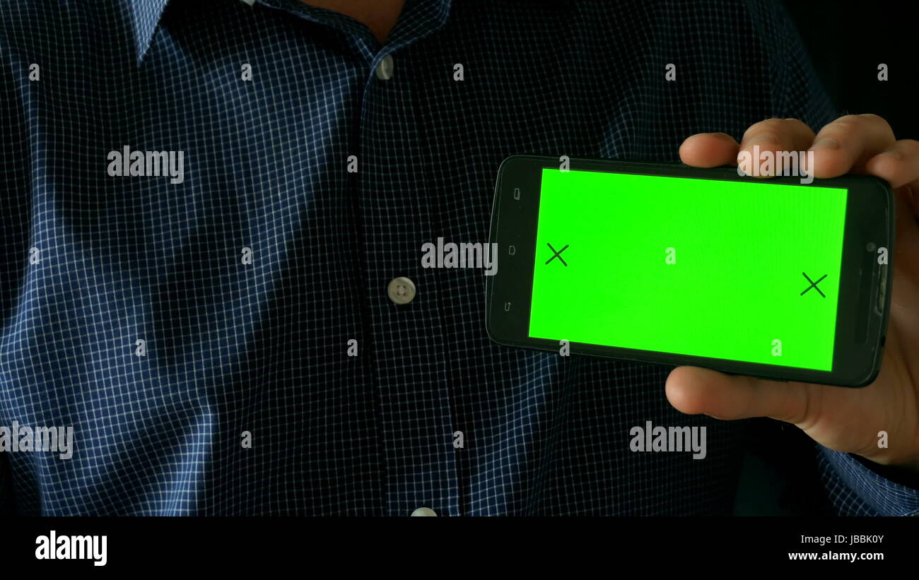 Close-up of male hands touching of smartphone. Green screen Chroma Key ...