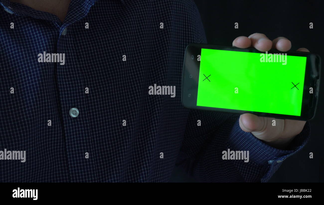 Close-up of male hands touching of smartphone. Green screen Chroma Key ...