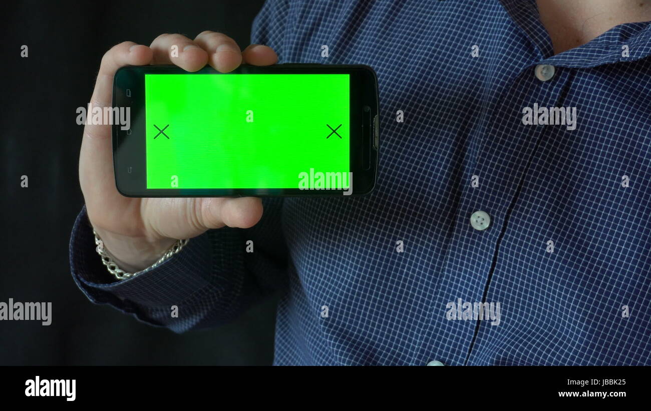 Close-up of male hands touching of smartphone. Green screen Chroma Key ...